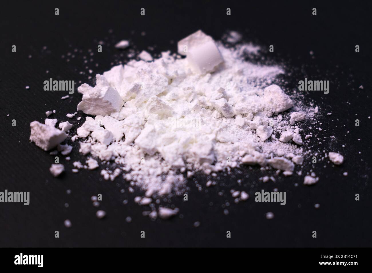 Powder from drugs on a black background. The concept of illicit trade ...
