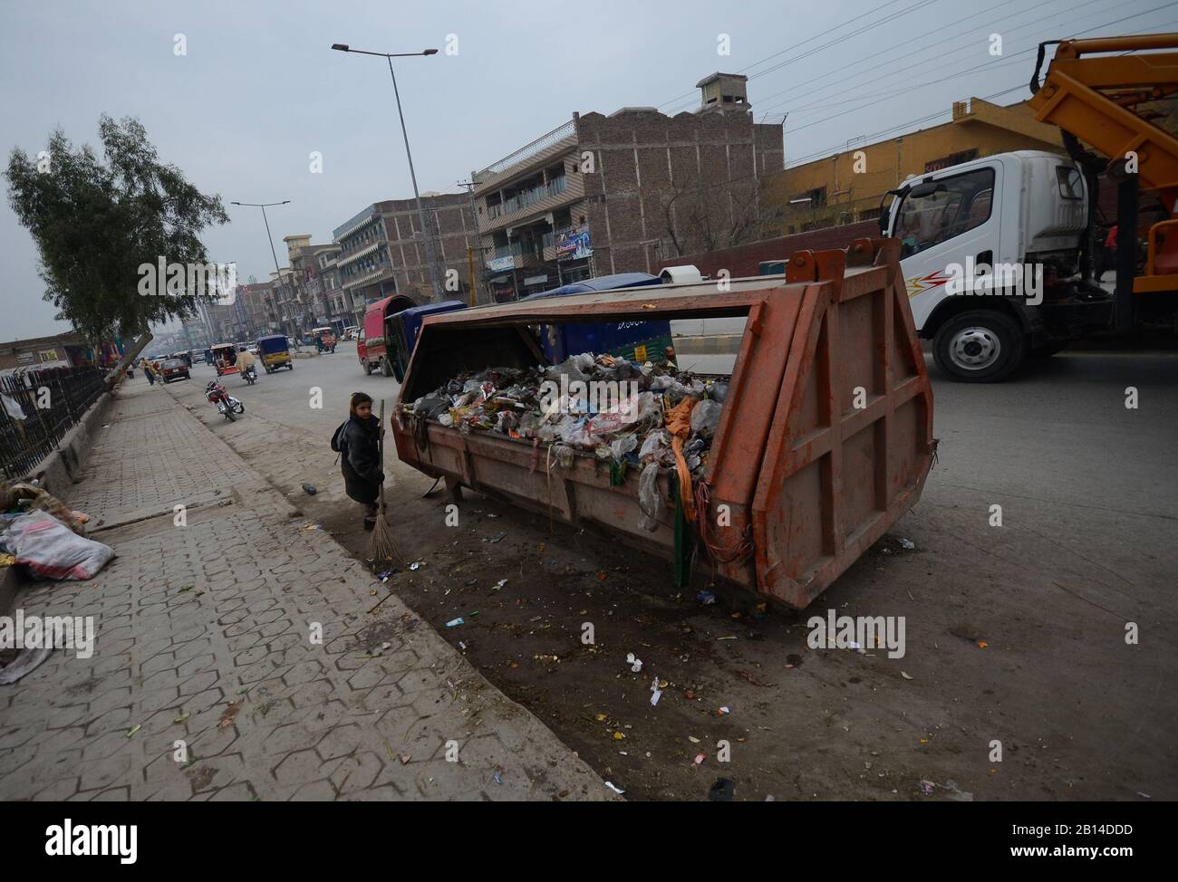 February 11, 2020: Peswahar, Pakistan. 11 February 2020. A child cleans ...