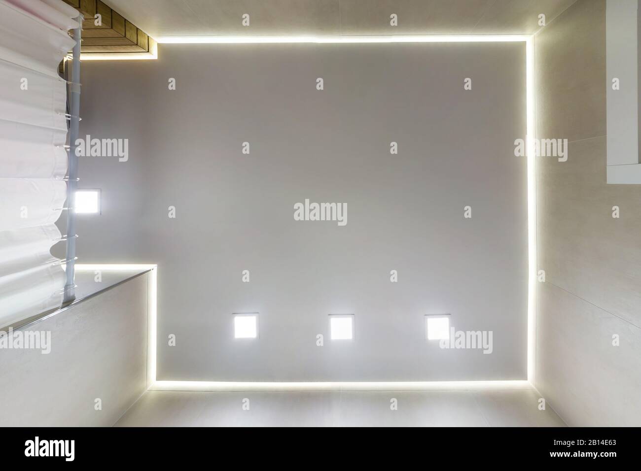 looking up on suspended ceiling with halogen spots lamps and drywall ...