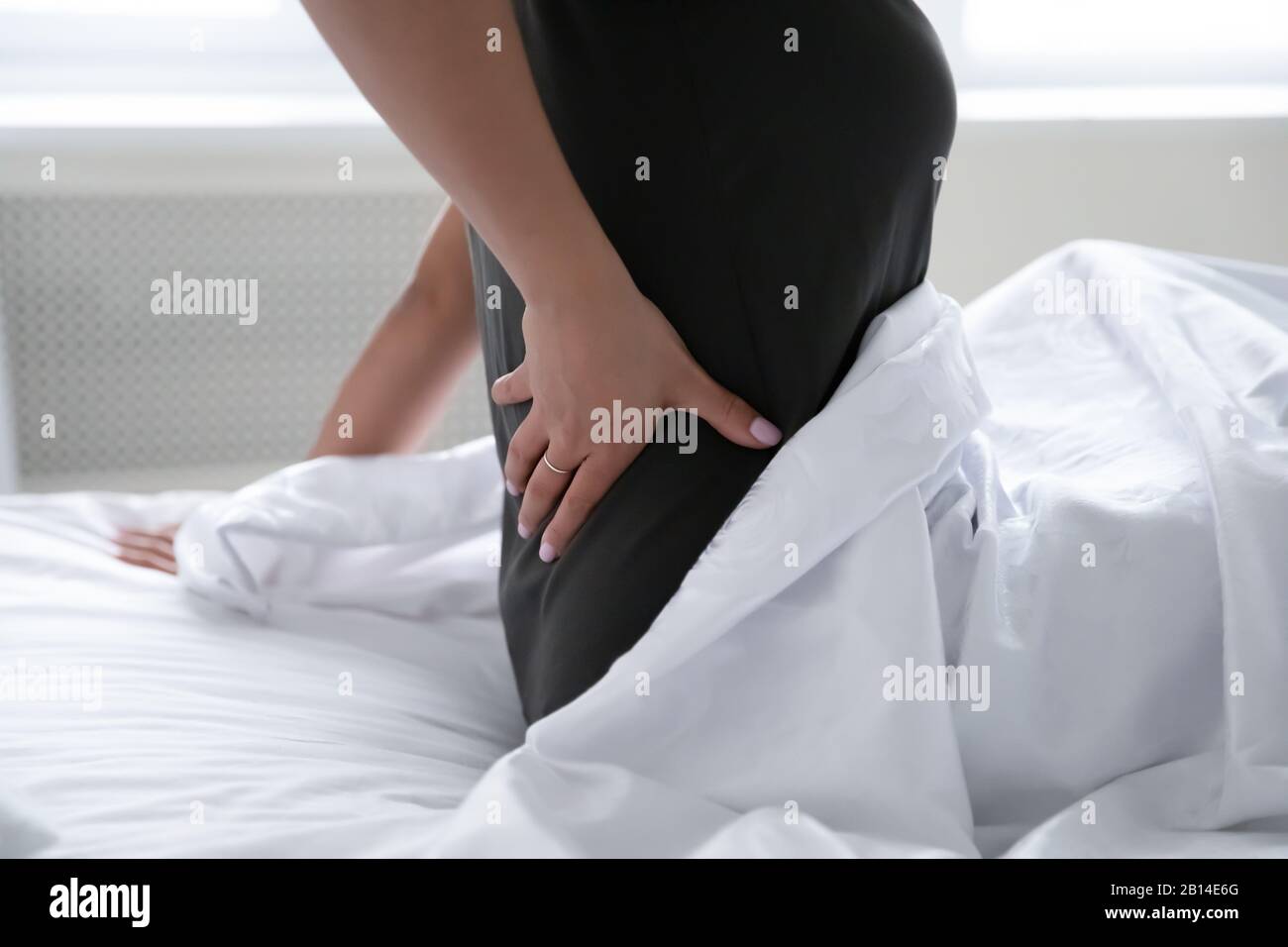 Unhealthy woman touch back suffering muscular spasm Stock Photo - Alamy
