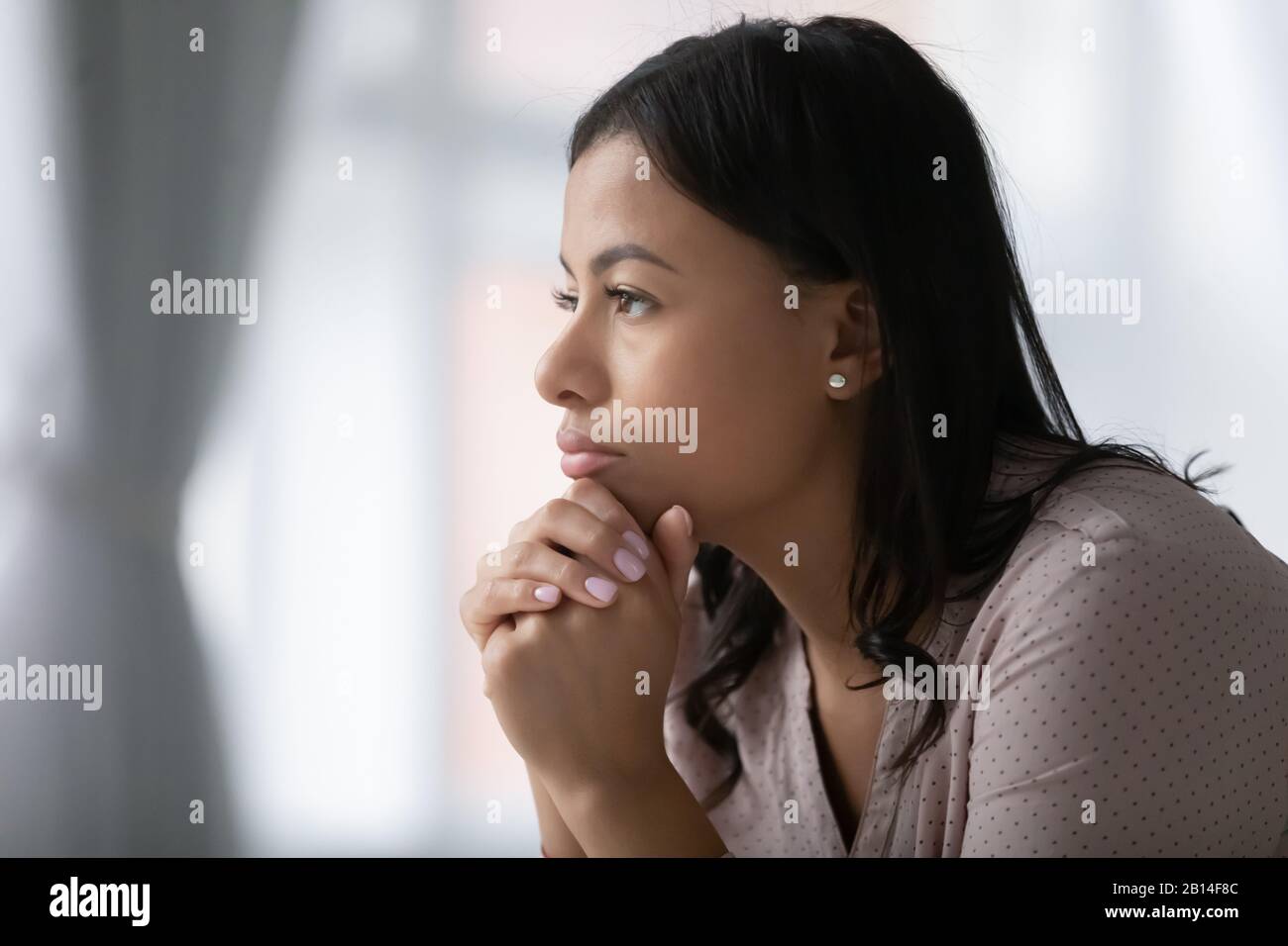 Pensive african American woman look in distance thinking Stock Photo ...