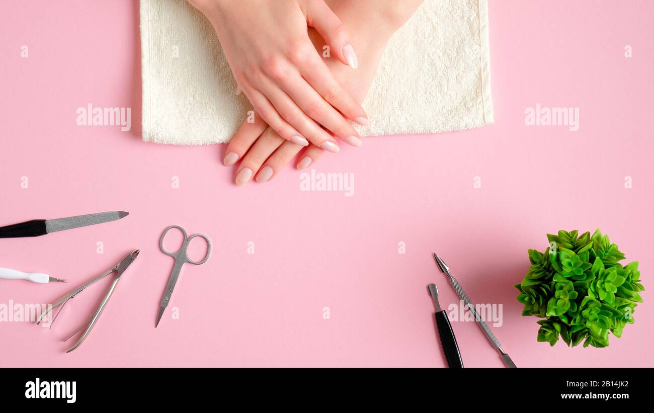 Nail salon workspace concept. Top view female hands and manicure tools ...