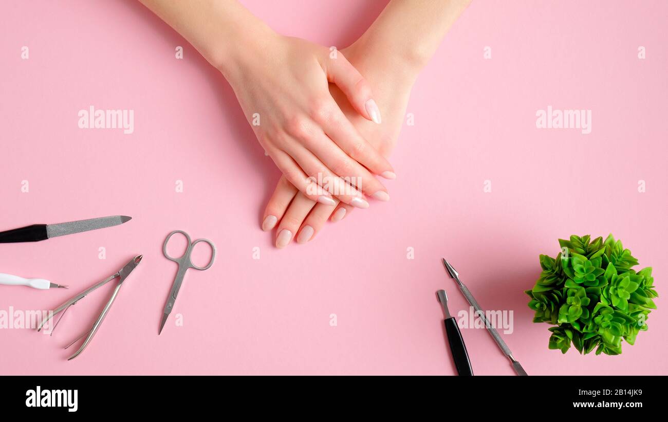 Woman getting professional manicure in nail salon. Top view female ...