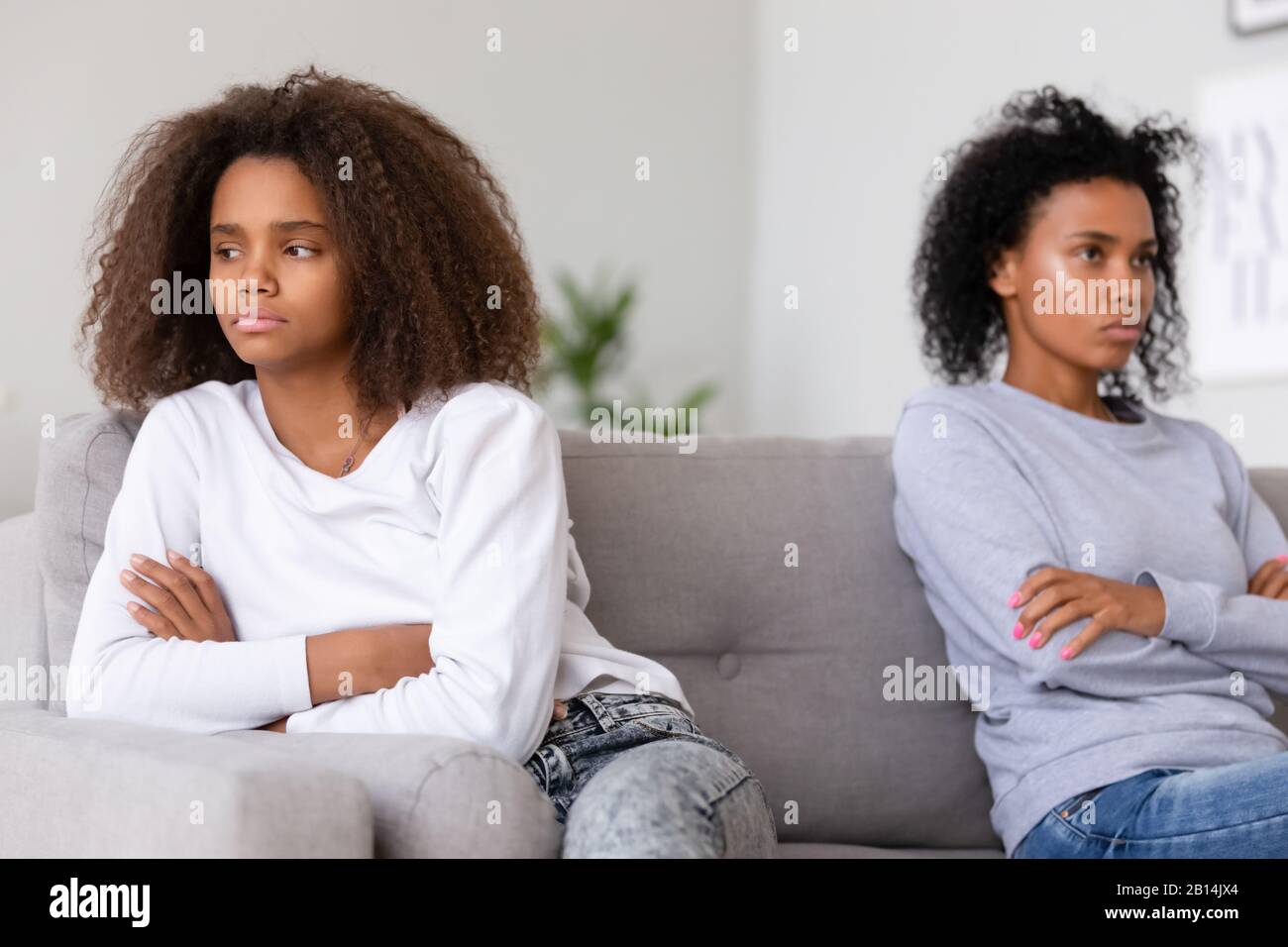 Stubborn african american teen daughter ignoring angry annoyed mom ...