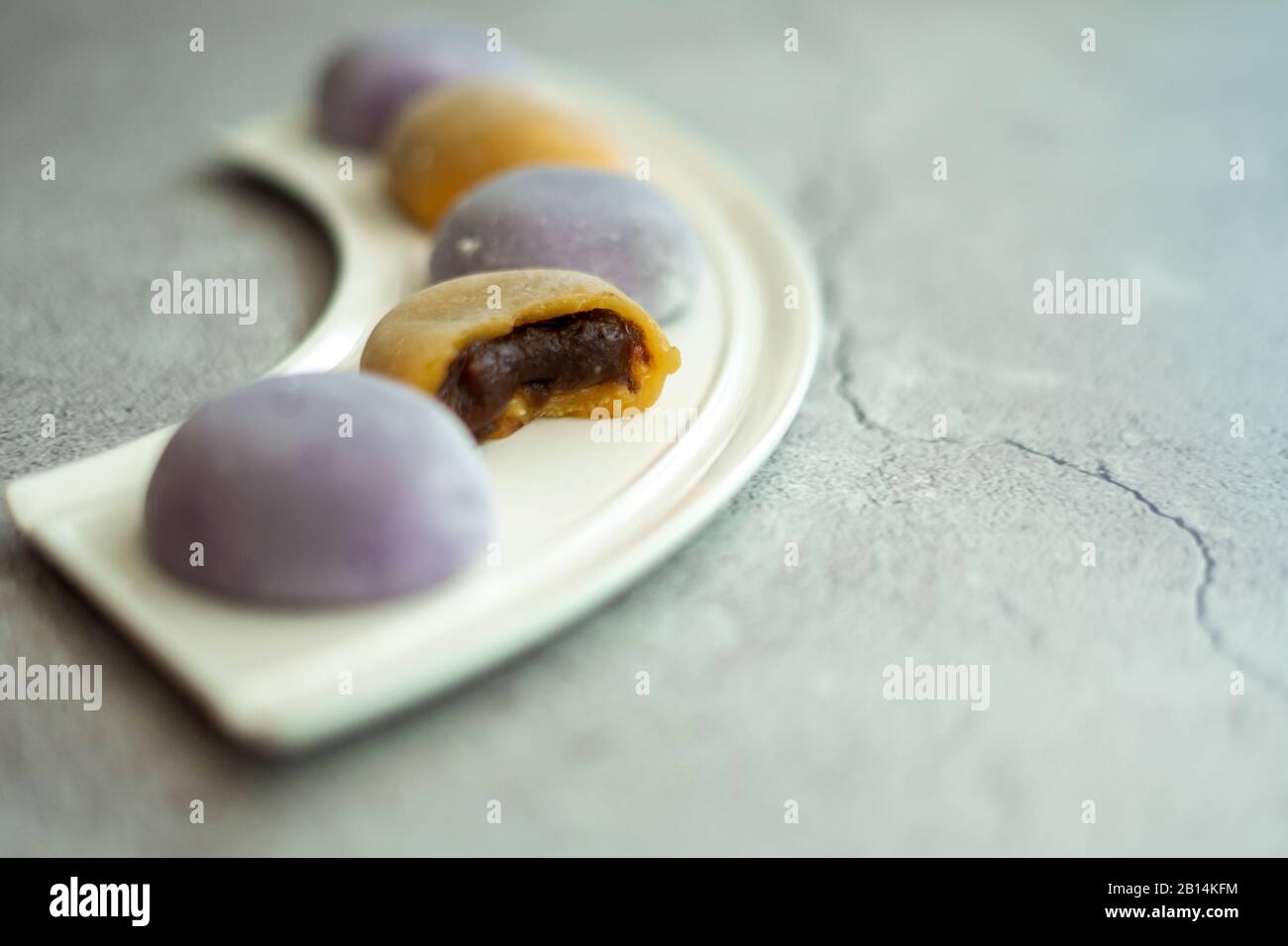 Multi-colored Japanese Mochi in rice dough and on a beautiful plate and ...