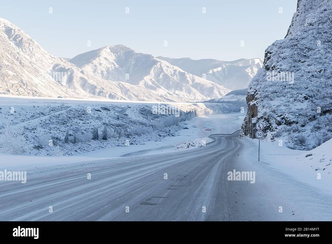 winter snowy landscape of a mountain valley with a river with a ...