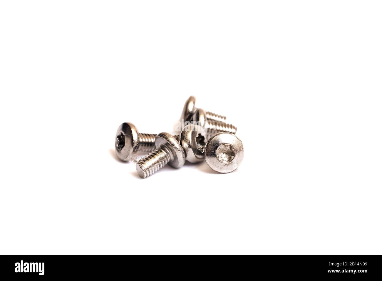 A pile of small bolts isolated on white background Stock Photo - Alamy