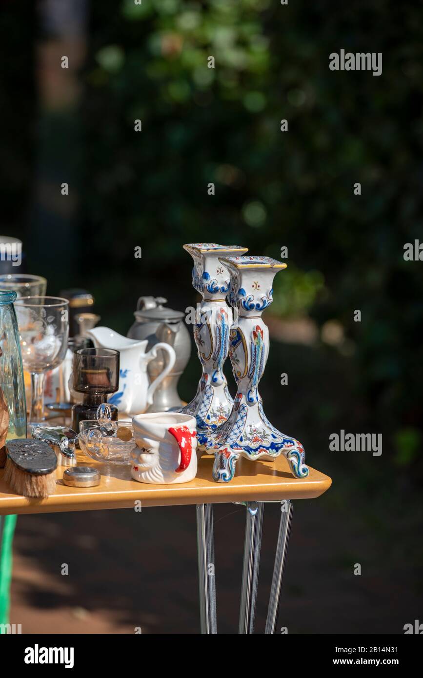 Flea market on a long crowded street, a lot of people selling their ...