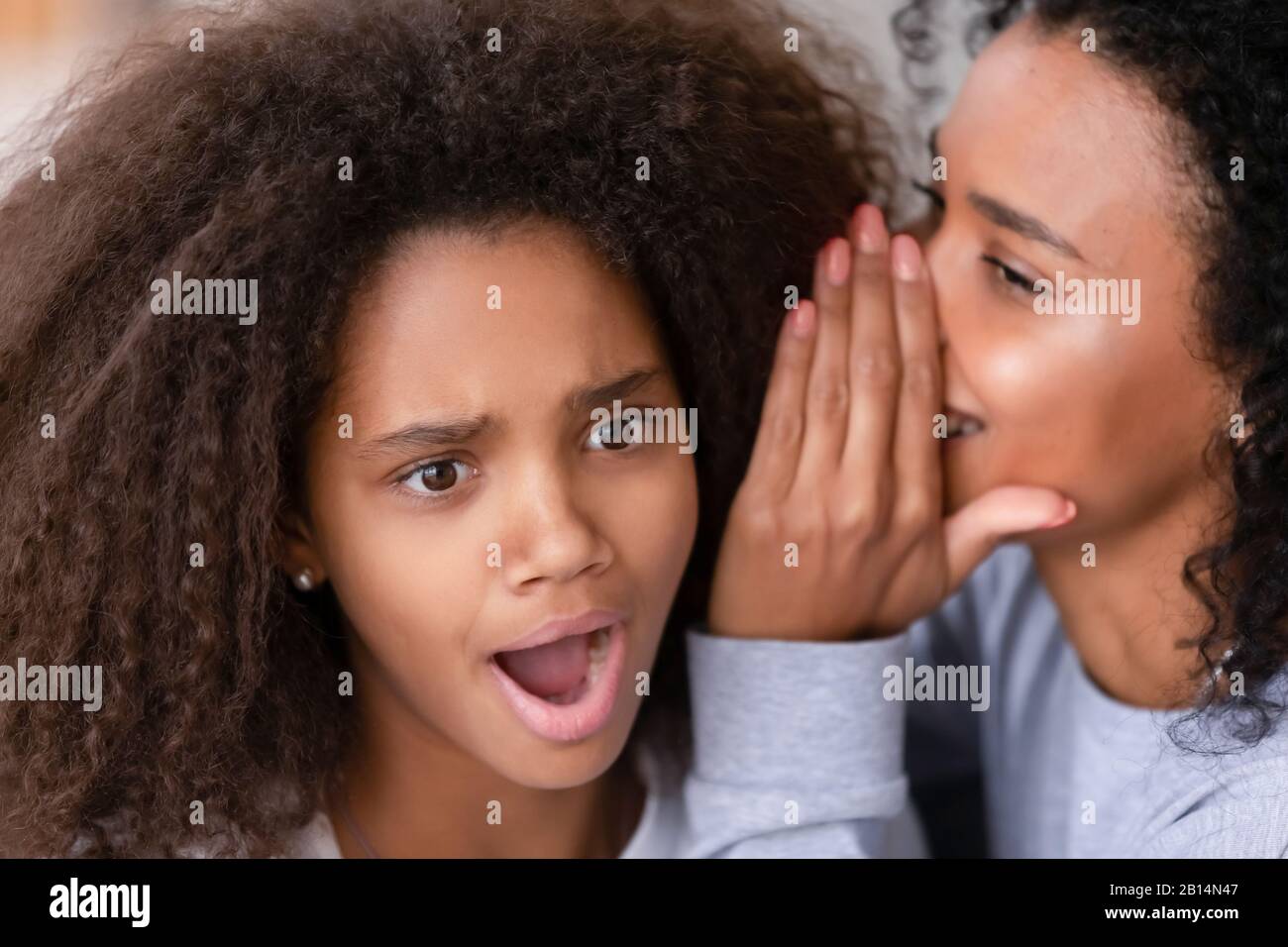 Child whispering mother hi-res stock photography and images - Alamy