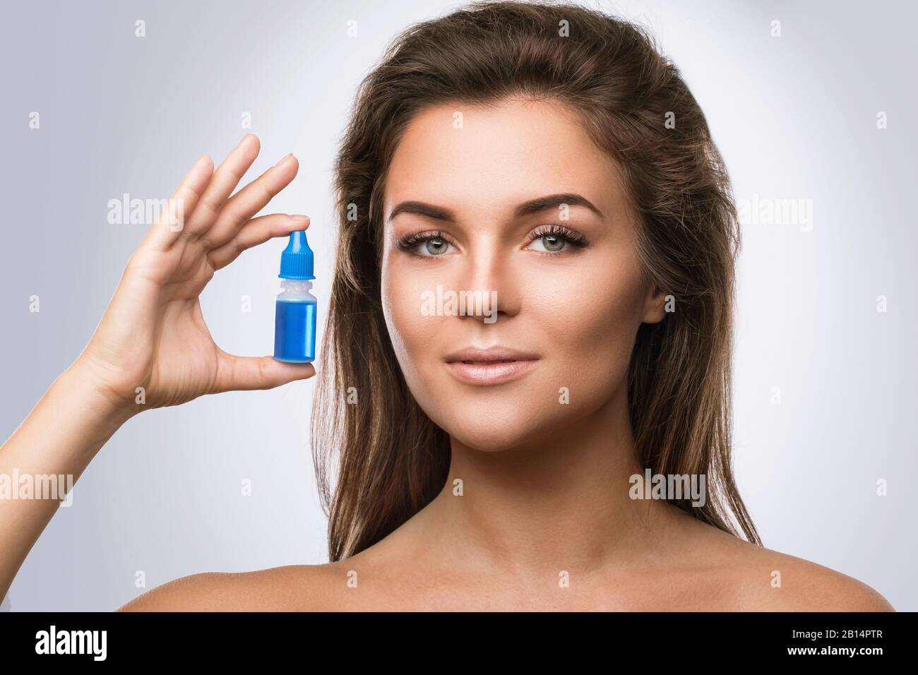 Beautiful woman using eye drops Stock Photo - Alamy