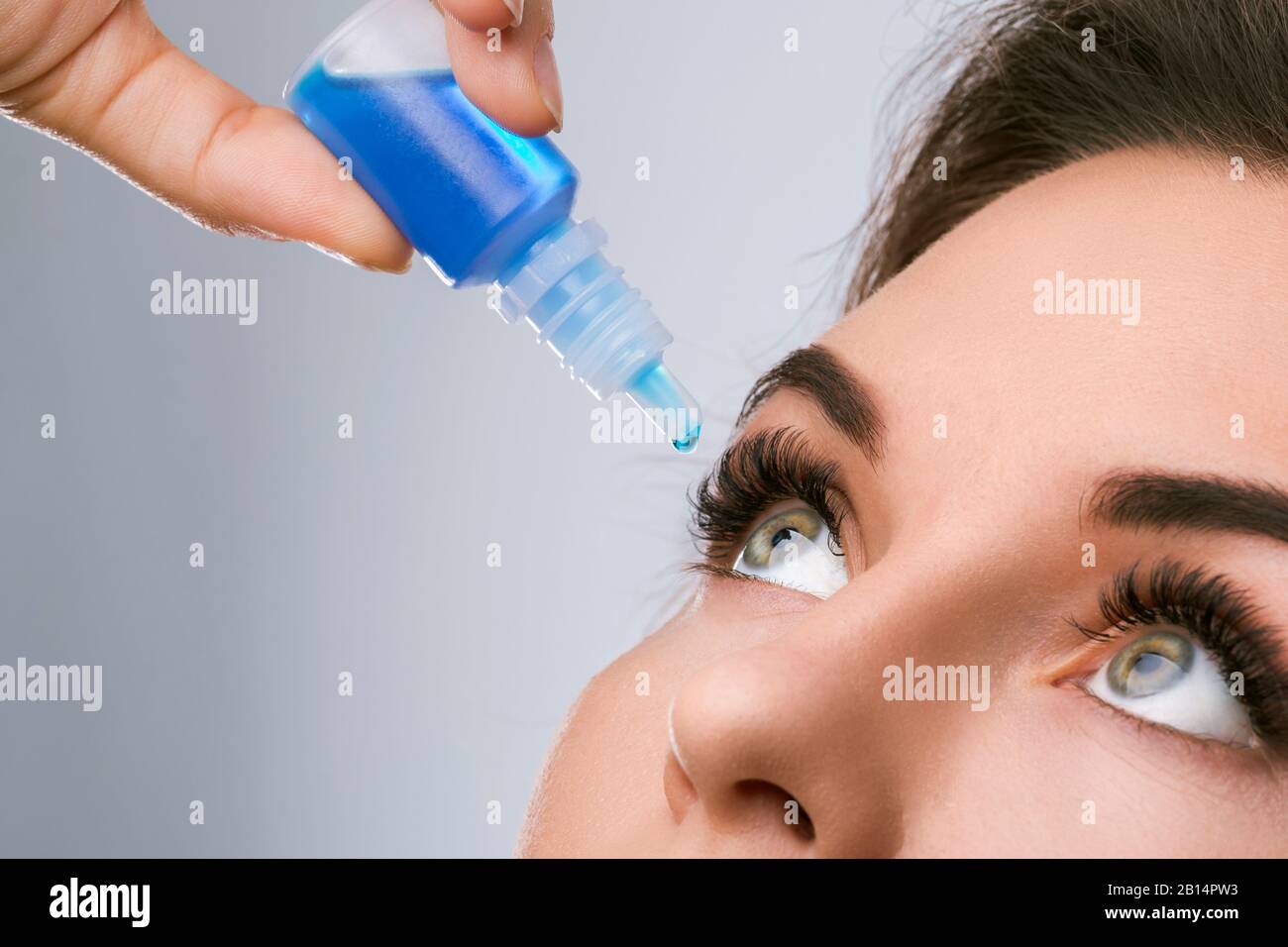 Close up of female face and eye drops Stock Photo - Alamy