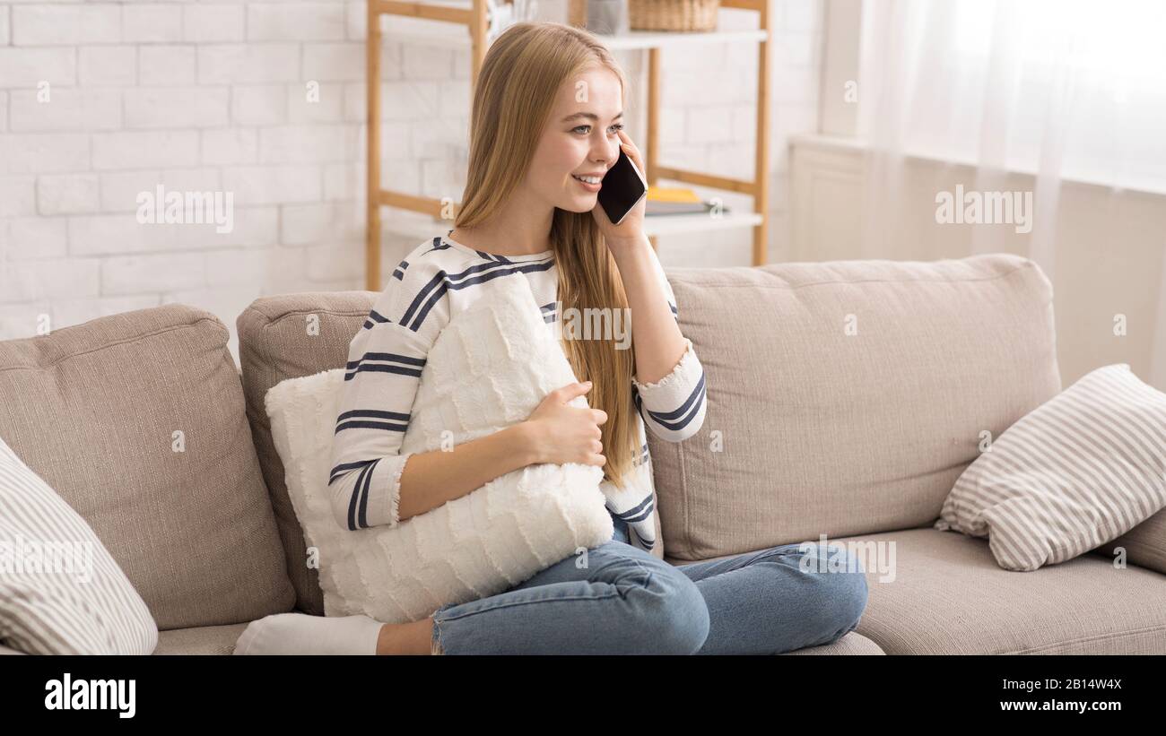 Smiling girl talking on smartphone with friends Stock Photo - Alamy