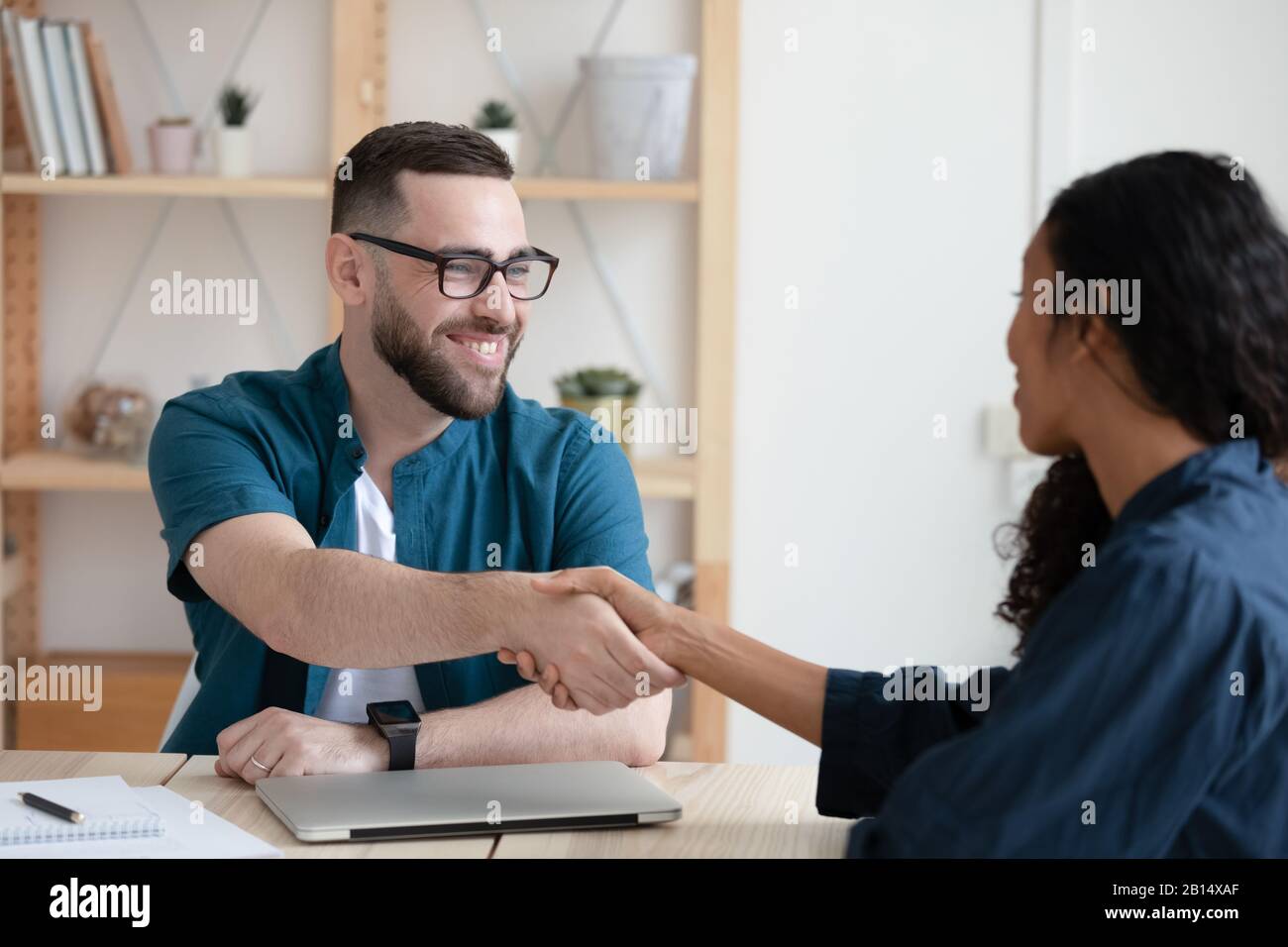 Smiling hr manager shaking hands with african american job applicant ...