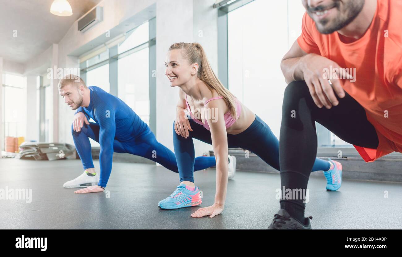 Group of people in gym fitness class stretching Stock Photo - Alamy