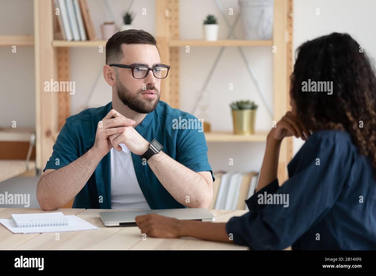 Focused young hr manager holding interview with african american ...