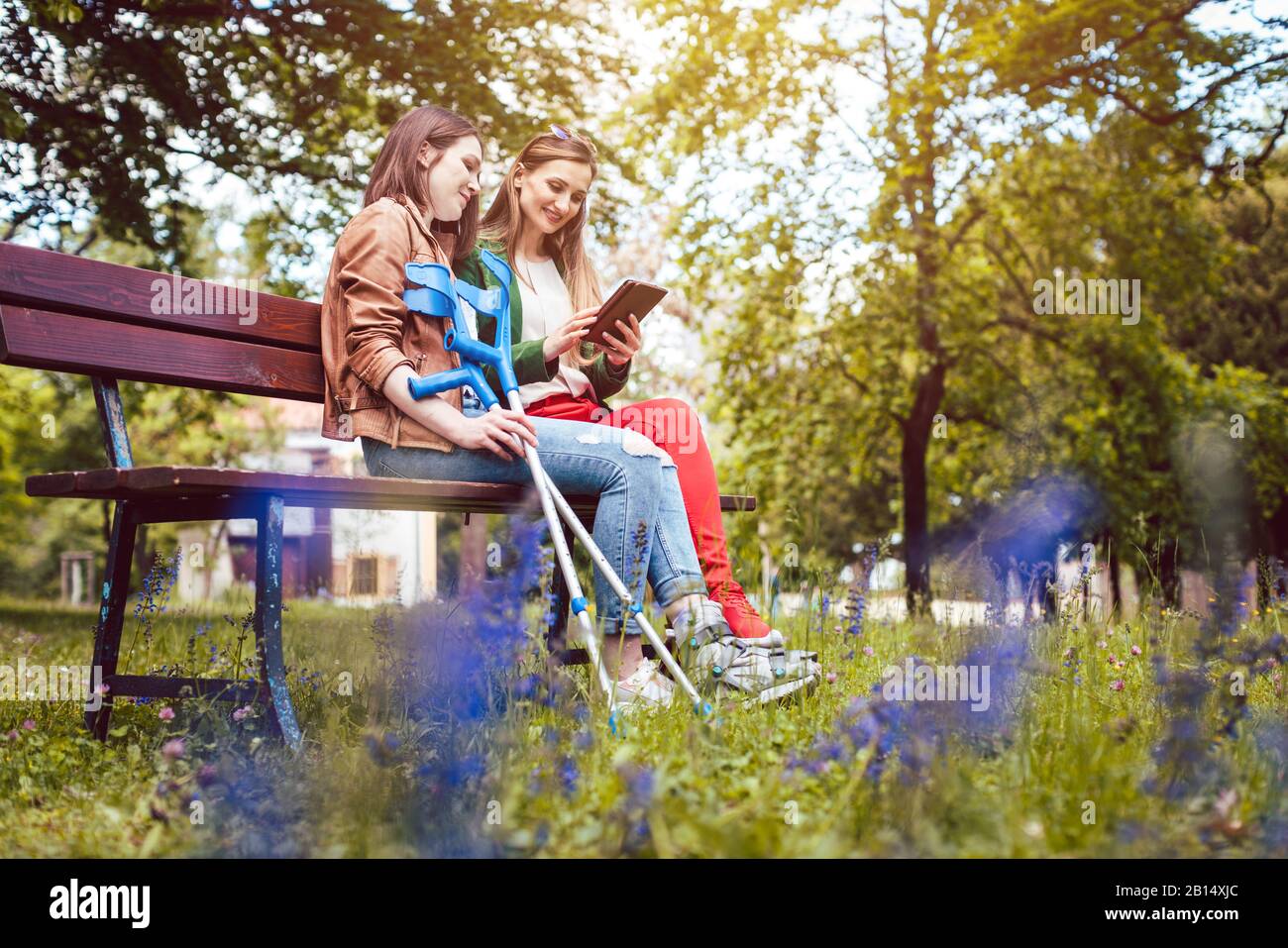 Woman spending time with her friend having a broken leg Stock Photo - Alamy