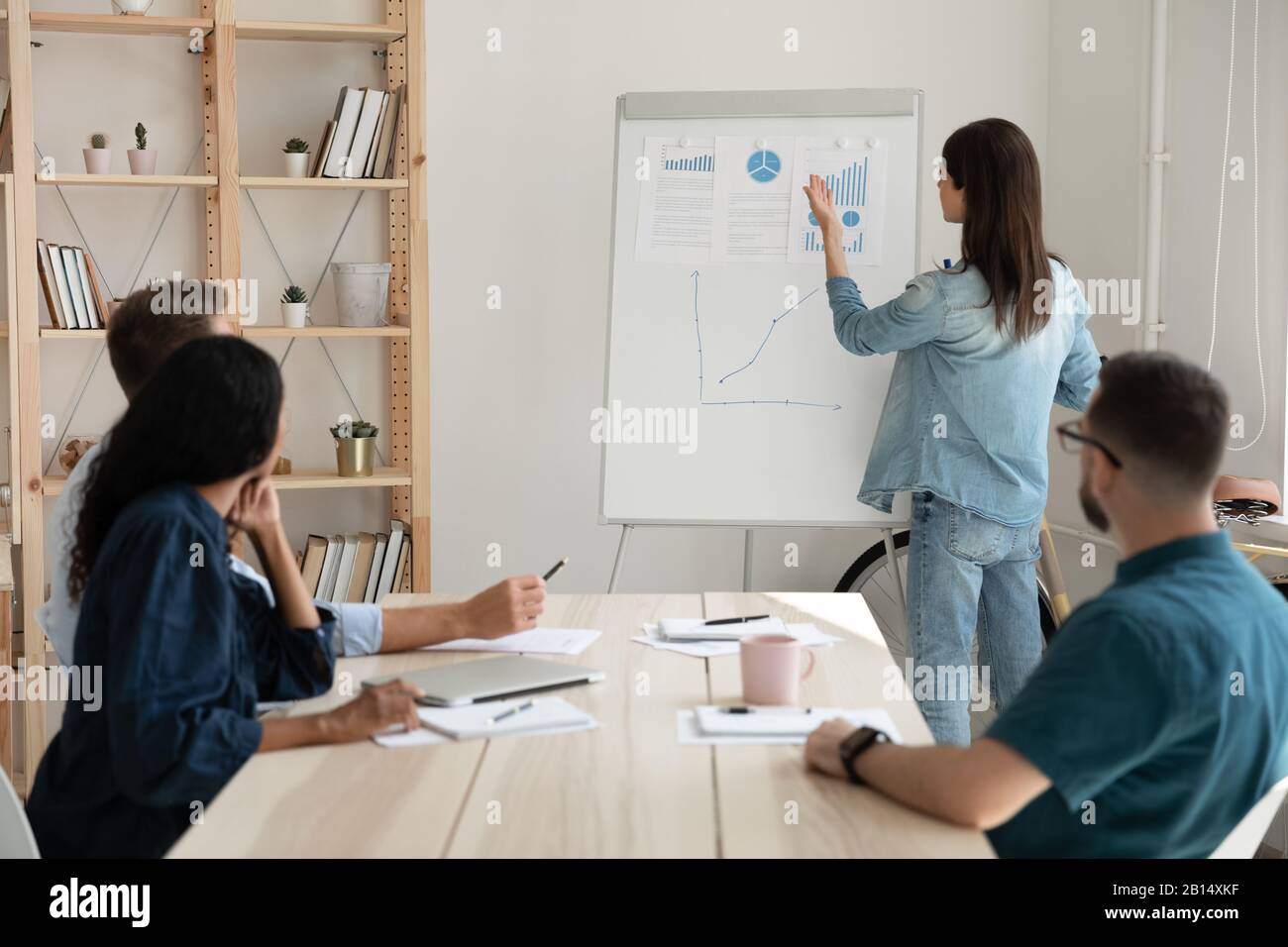 Focused mixed race company workers listening to skilled female ...