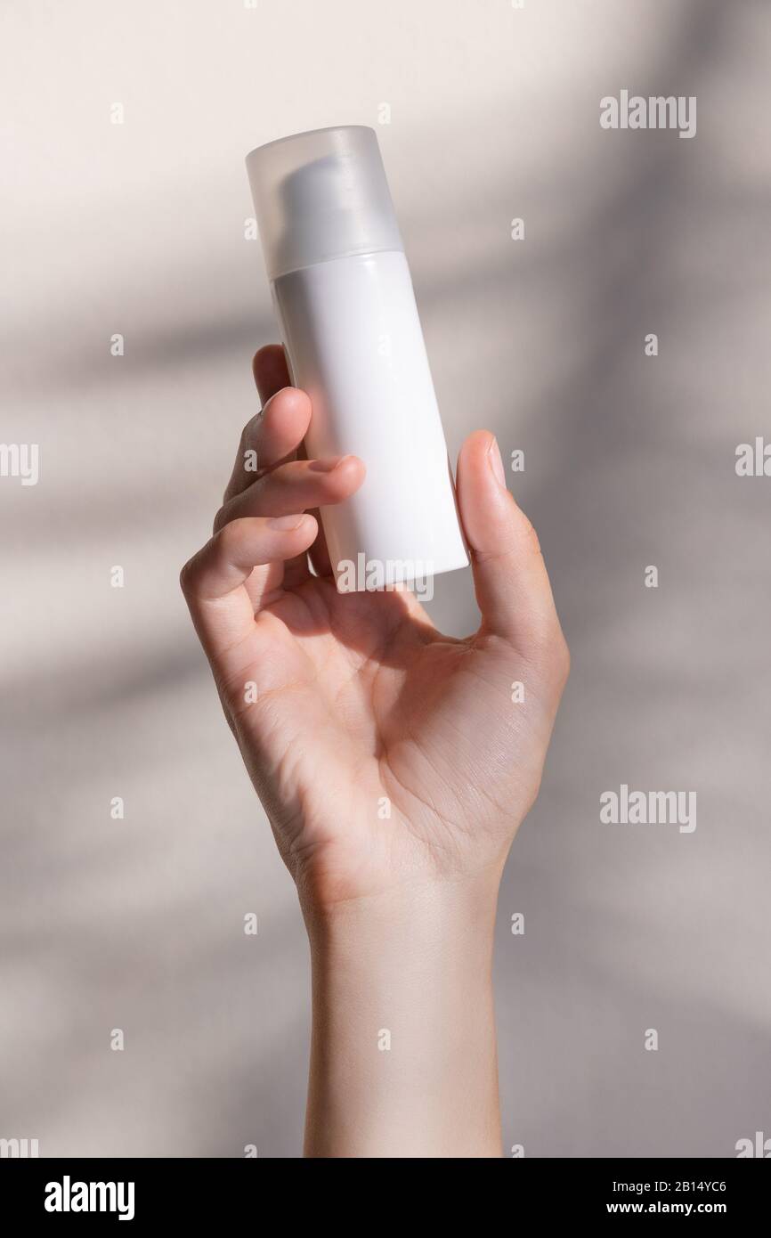 Women's hands with cosmetic moisturizing cream lotion on beige ...