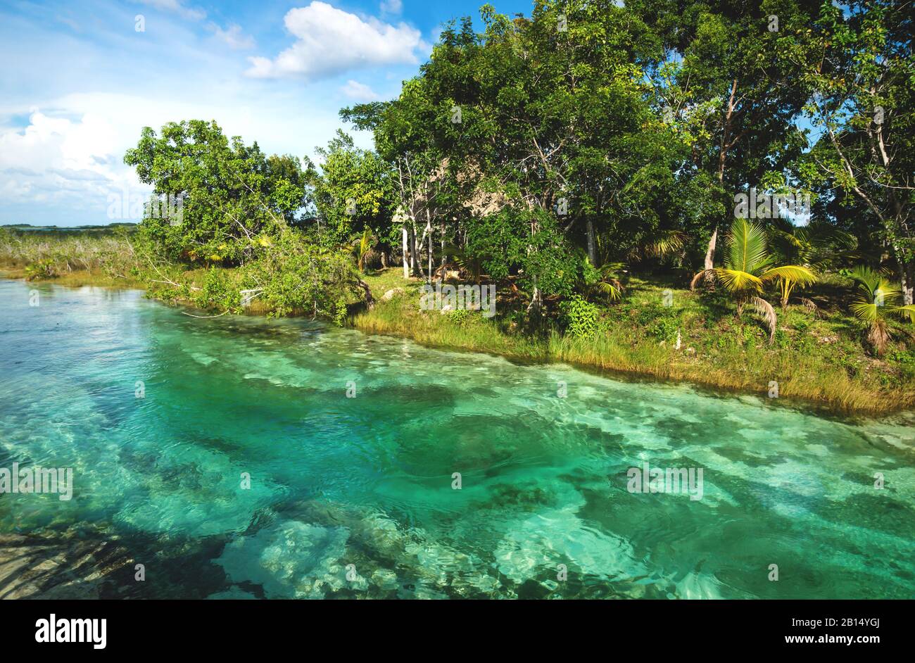 Rapids at sunny seven colored lagoon surrounded by tropical plants in ...