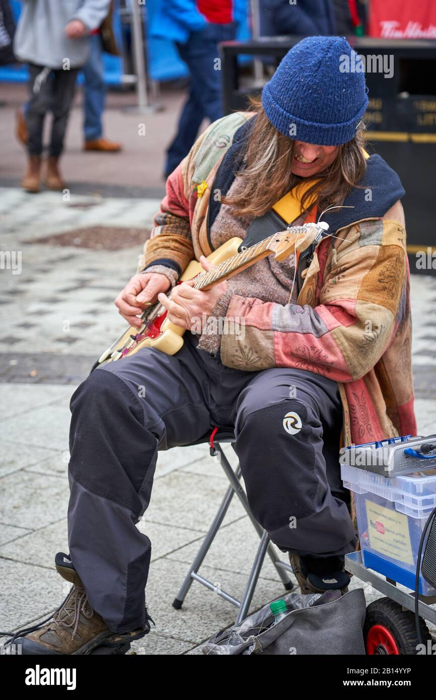Guitarist Mark Allen busking on Queen Street, Cardiff, South Wales ...