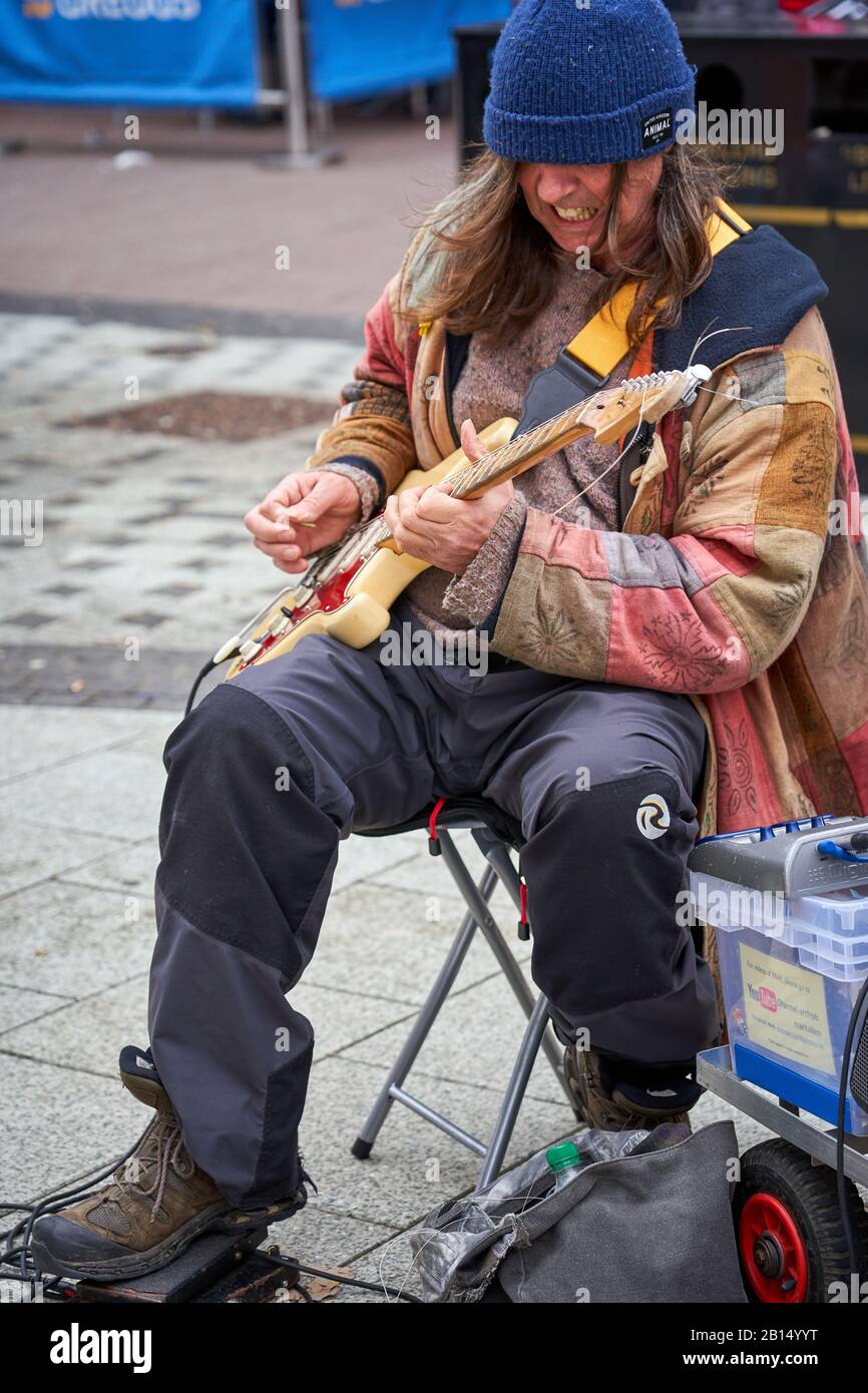 Guitarist Mark Allen busking on Queen Street, Cardiff, South Wales ...