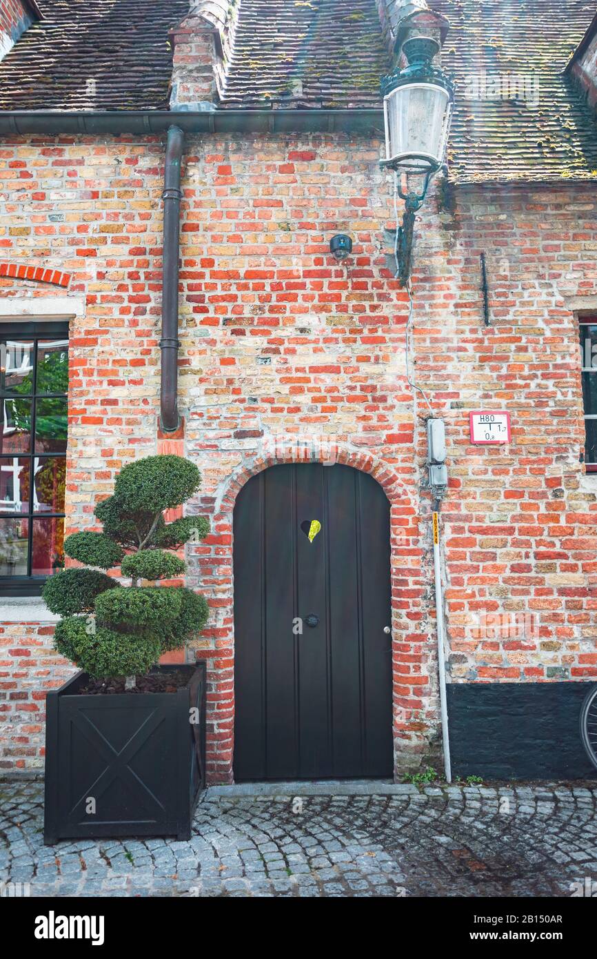 Beautifully decorated house entrance with red brick walls, a small ...