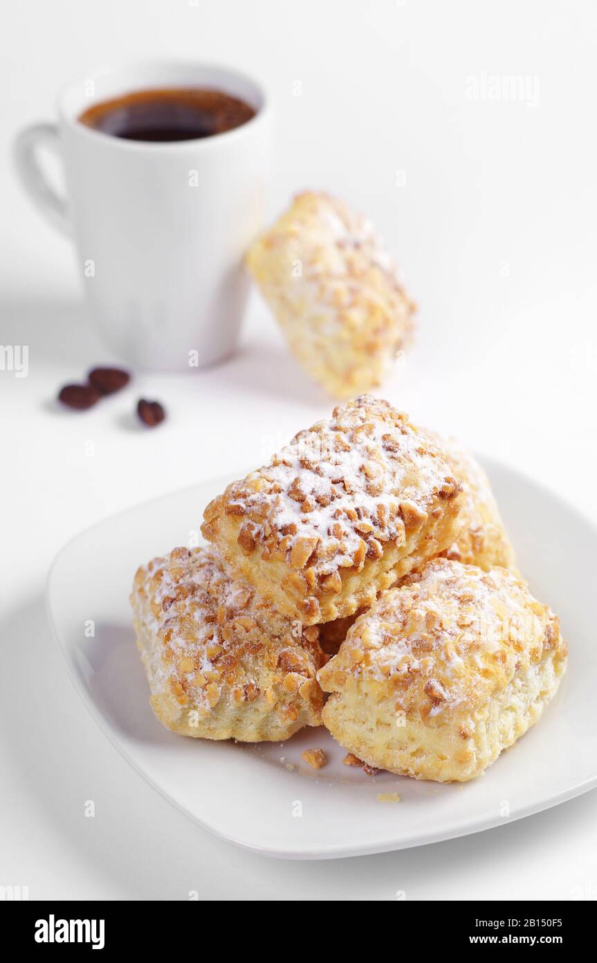 Puff cookies with nuts and cup of coffee on white background Stock ...