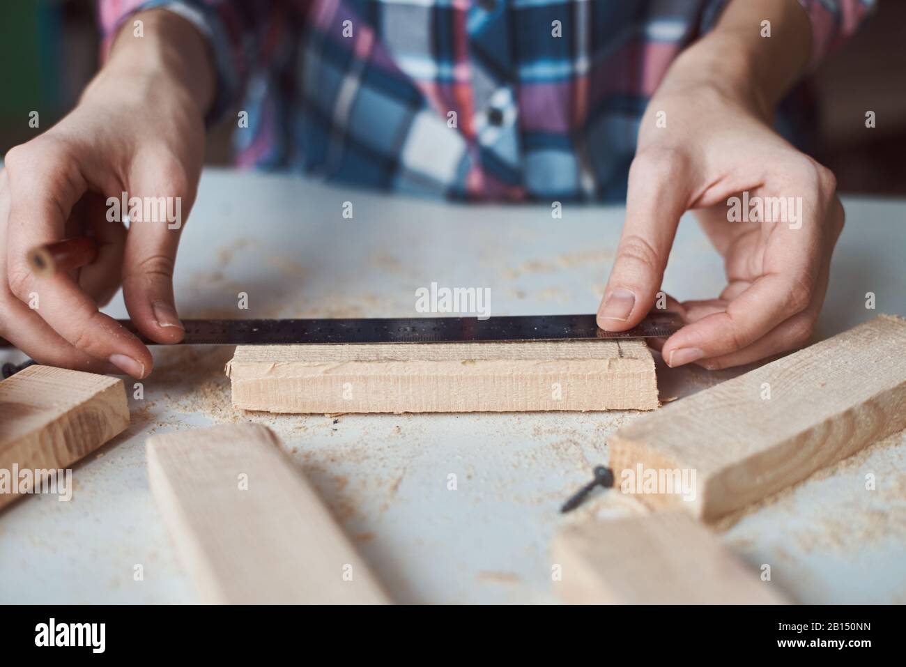 Carpenter hands taking measurement with pencil of wooden plank. Concept ...