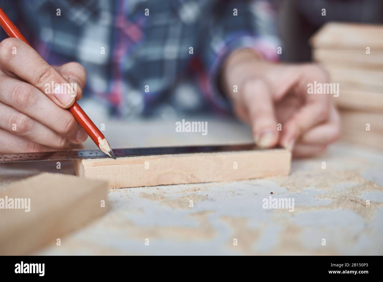 Carpenter hands taking measurement with pencil of wooden plank. Concept ...