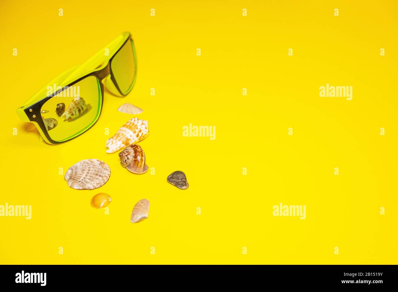 Sun glasses sea shells bright yellow background. Concept summer ...