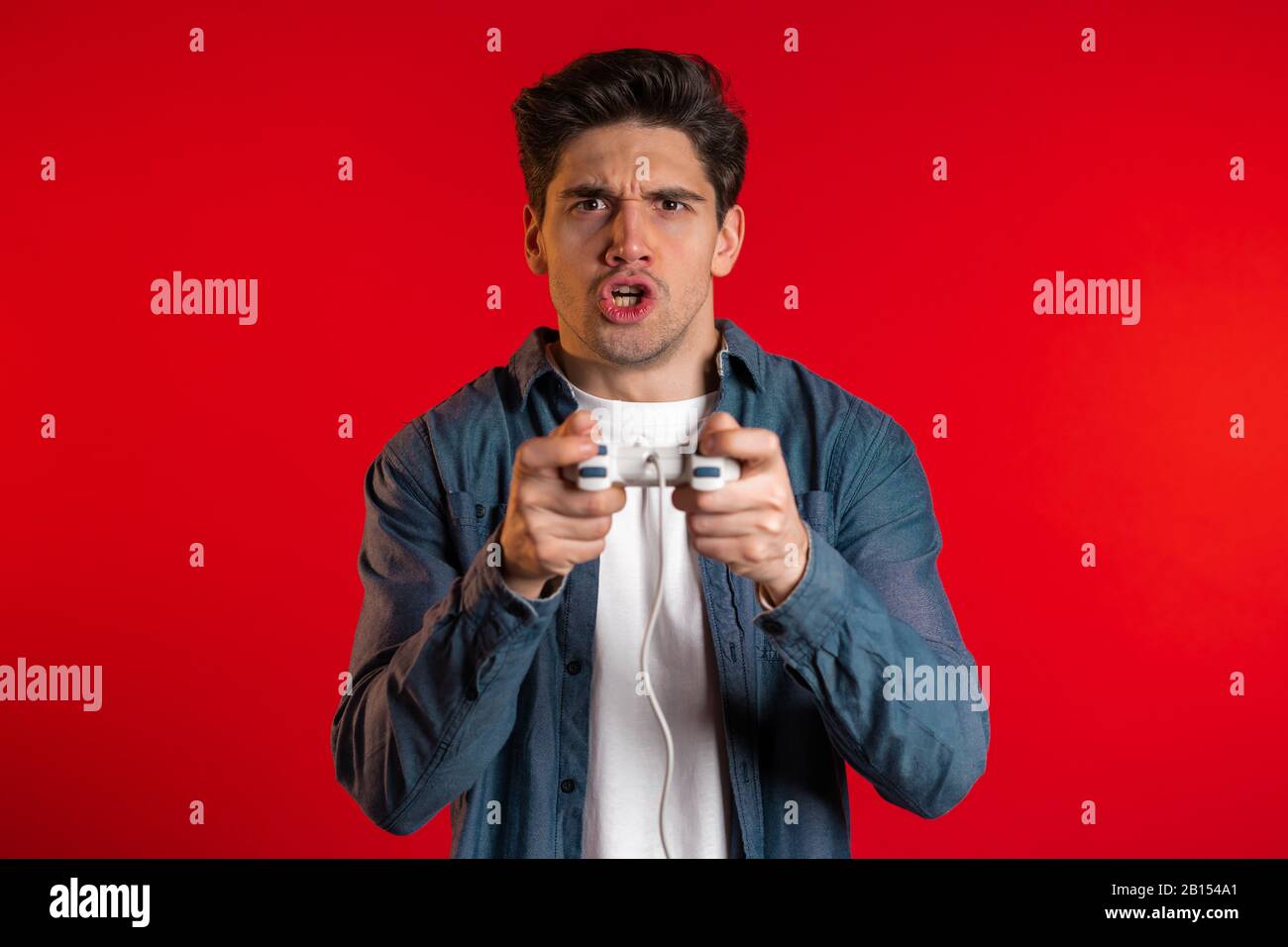 Handsome young man playing video exciting game on Tv with joystick on ...