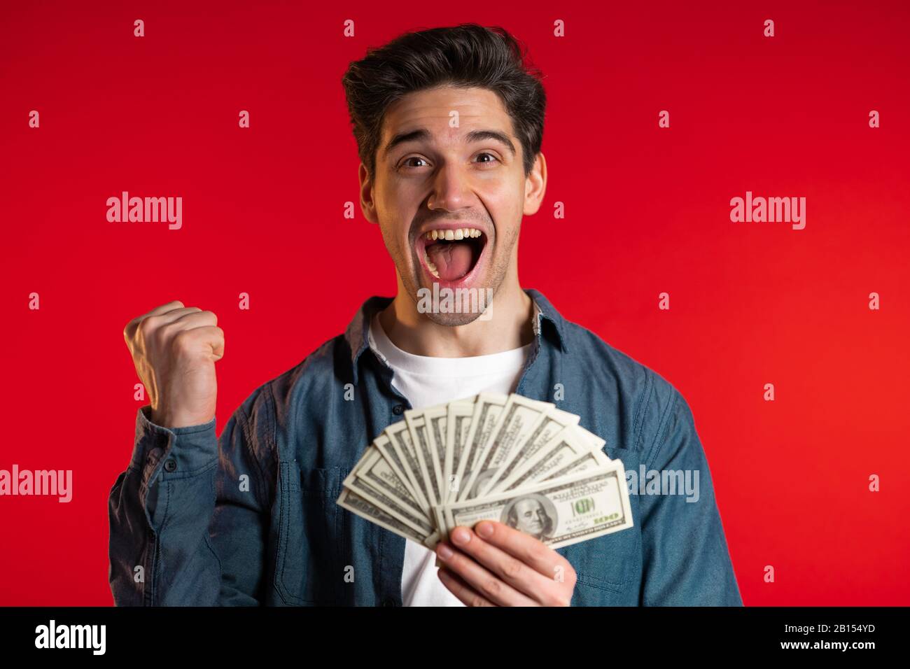 Satisfied happy excited man showing money - U.S. currency dollars ...