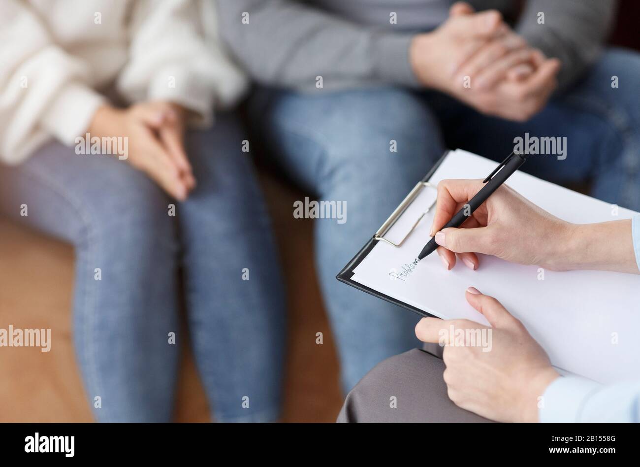 Marriage Consultant Taking Notes Talking With Couple In Office, Cropped ...