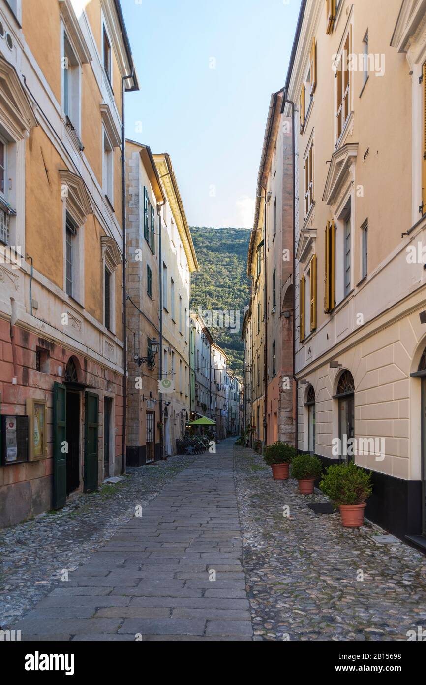 View along narrow street in the medieval village of Finalborgo in ...