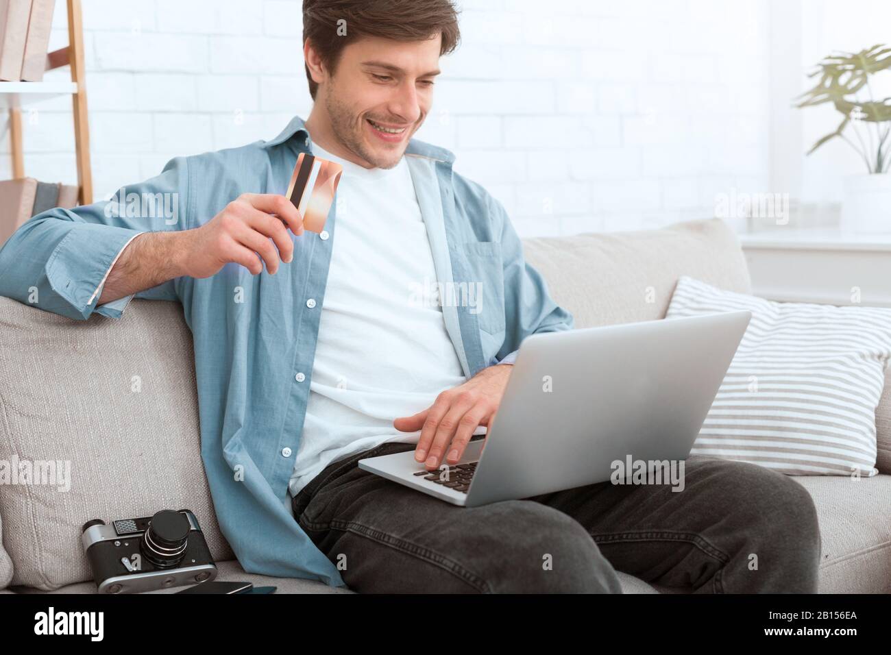Young man preparing for trip, booking tickets online Stock Photo - Alamy