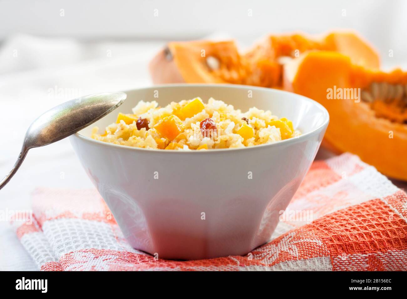 Sweet milky millet and rice porridge with pumpkin and raisins Stock ...