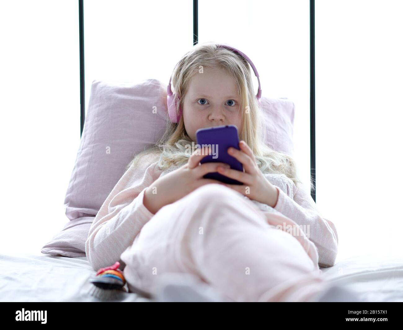 modern life of generation Z. teenage girl in pajamas and headphones in ...