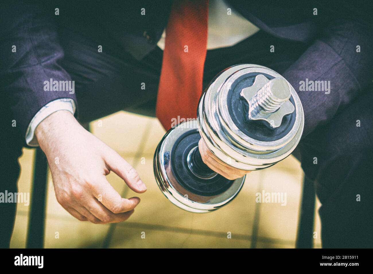 Man lifting dumbbell sitting on hi-res stock photography and images - Alamy