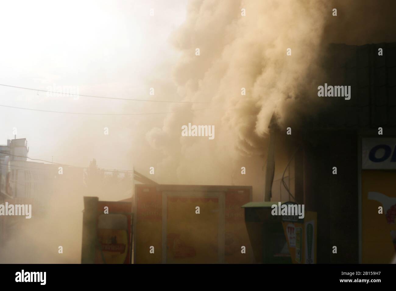Burning building in the city. Fire extinguishing operation Stock Photo ...
