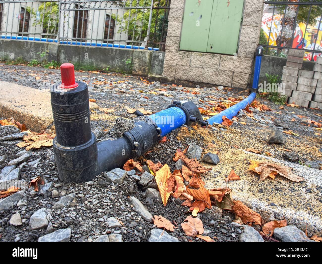 HDPE blue tube connected by black bent part to city drinking water ...