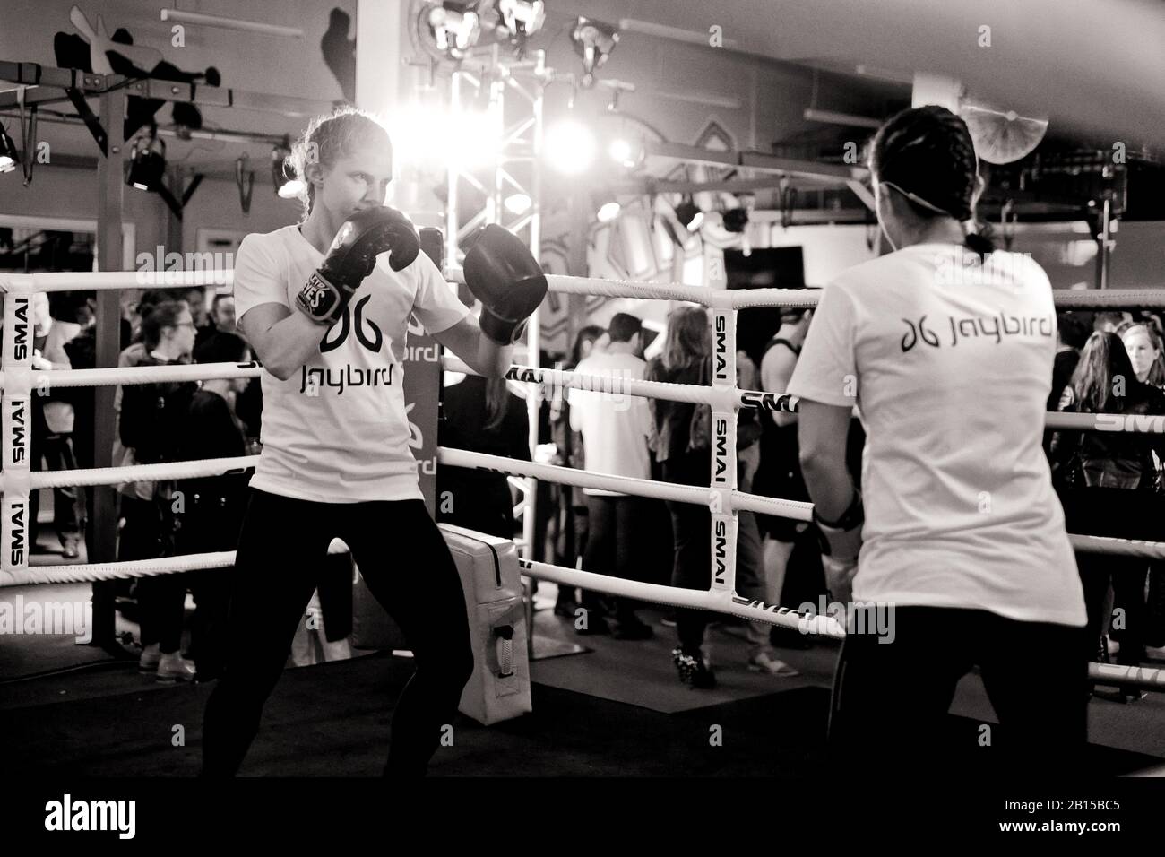 Two female athletes sparring and training in a boxing ring, woman and ...