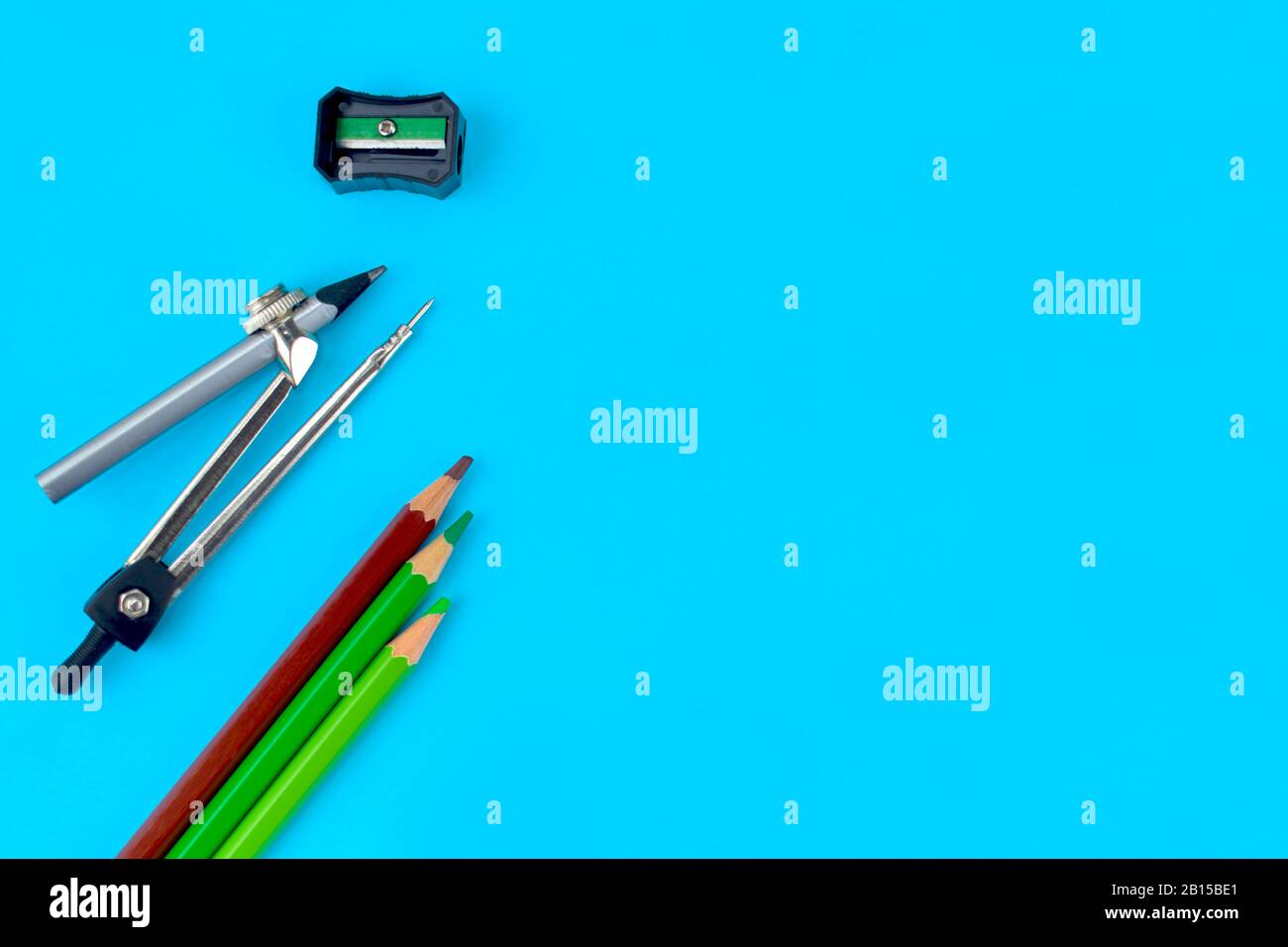 A black pencil sharpener along side a pencil attached to a pencil ...