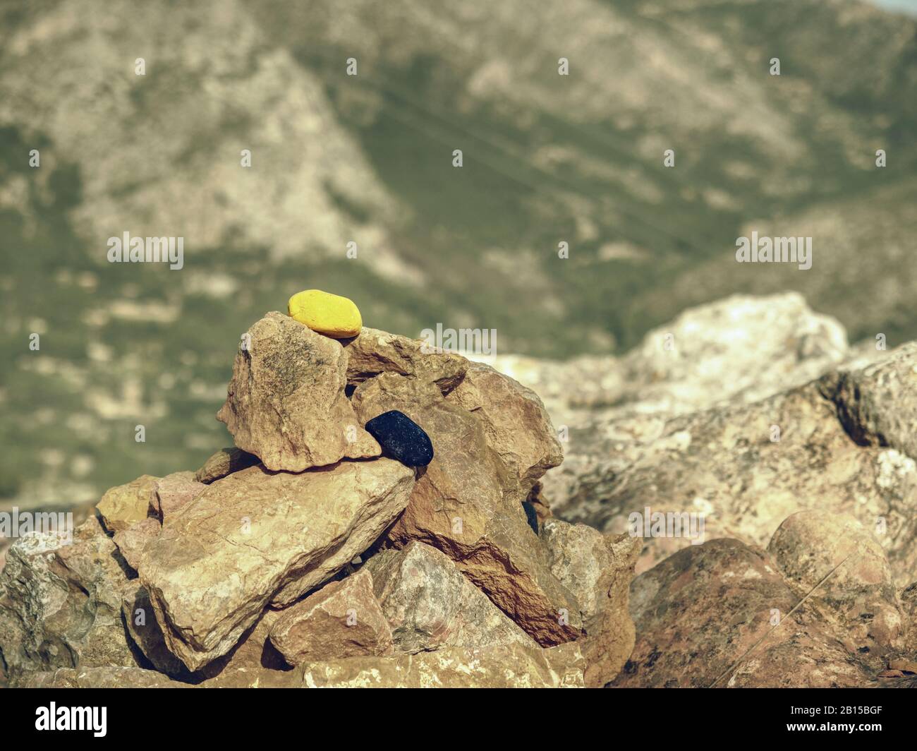Follow way marked with yellow and blue stones. Stony pile stacked at ...
