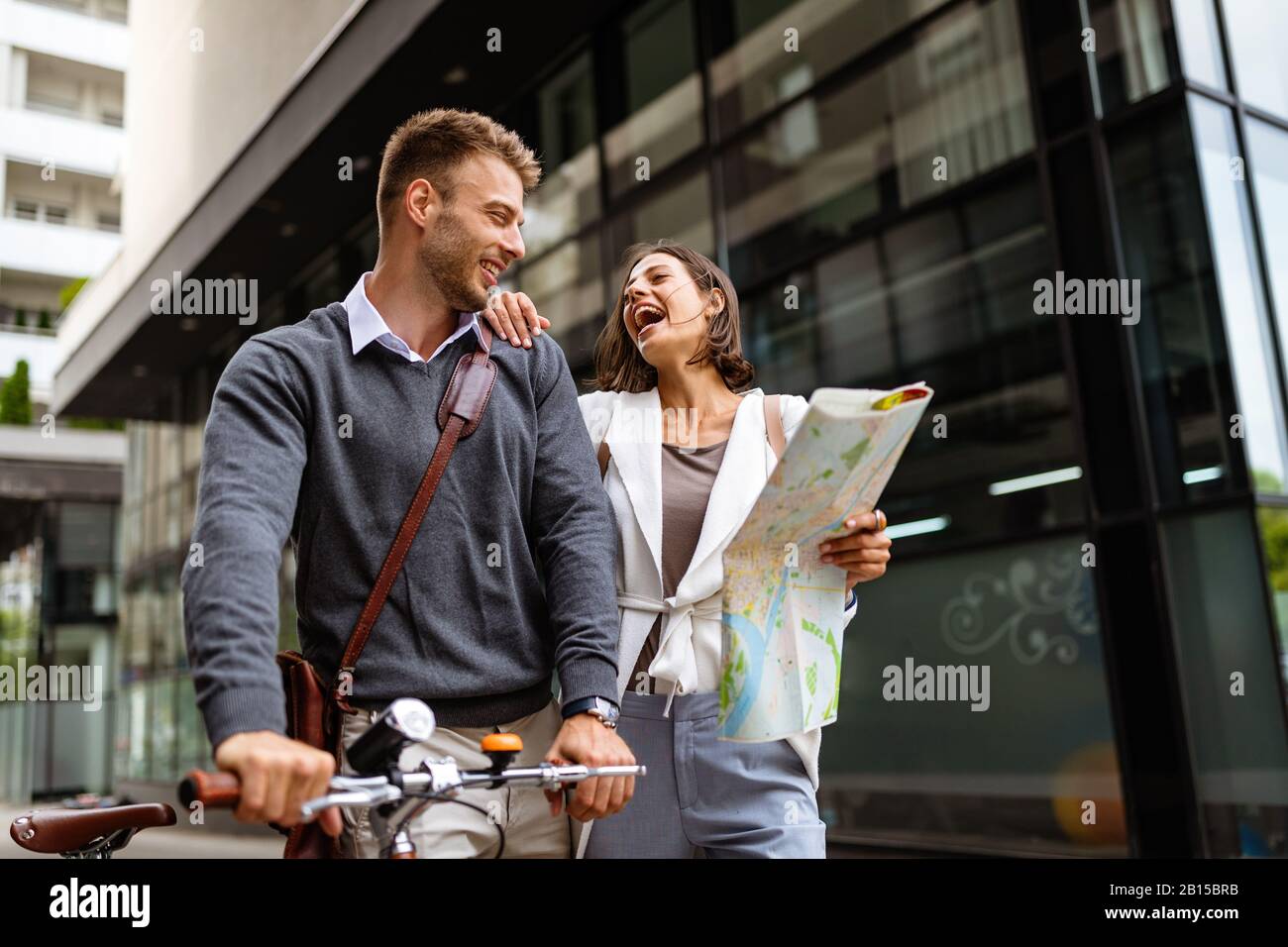 Happy smiling woman and man in love walking with map in the city Stock ...
