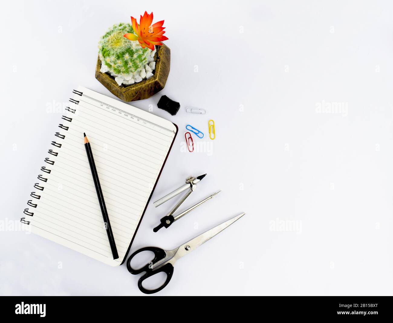 Study materials including a notebook,a black pencil a scissor a pencil ...