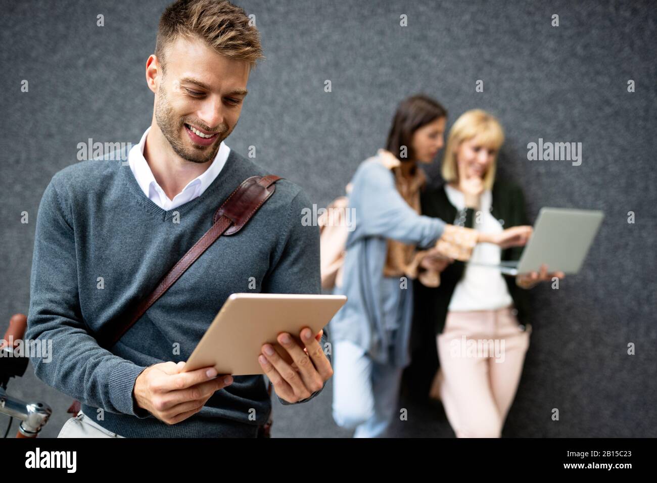 Group of business people using electronic devices outdoor Stock Photo ...