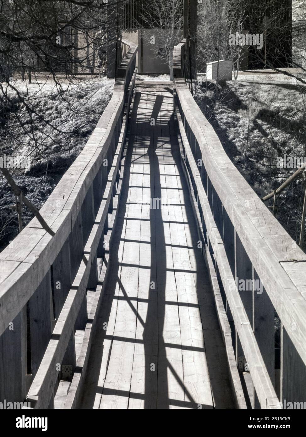 unusual landscape with wooden bridge over river, infrared photo taken ...