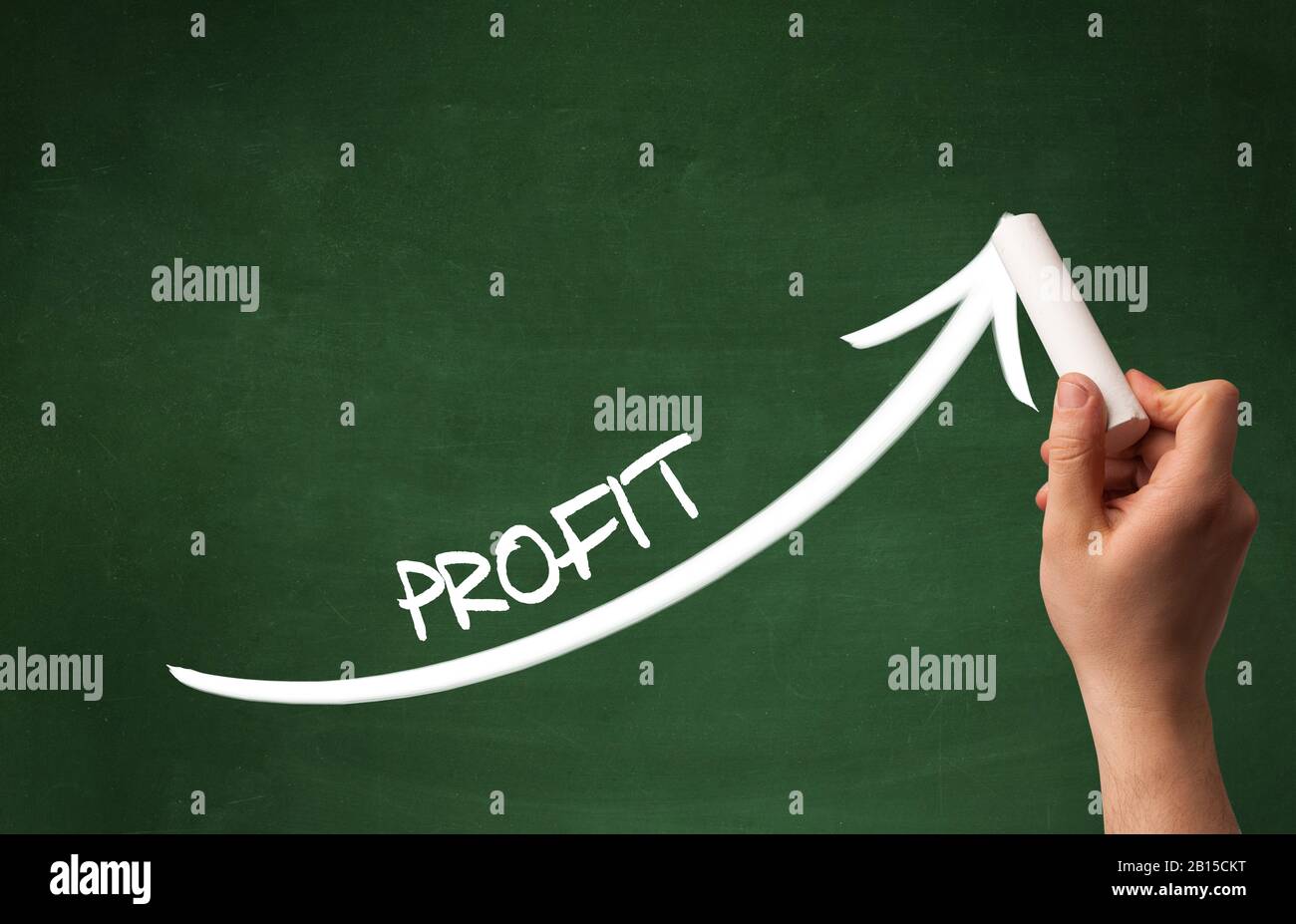 Hand drawing PROFIT inscription with white chalk on blackboard ...