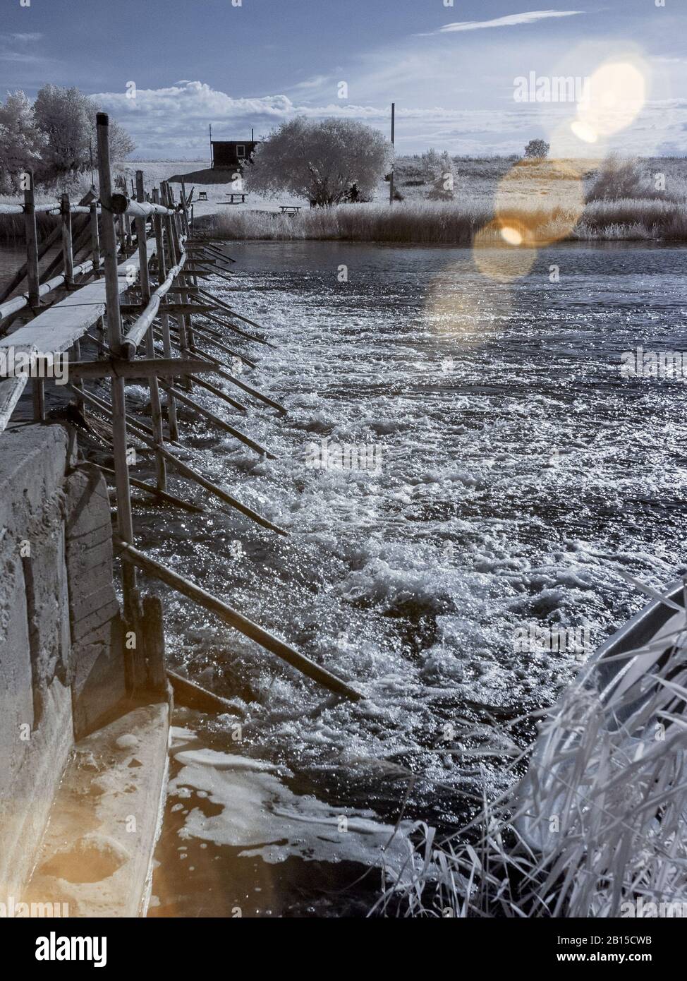 unusual landscape with wooden bridge over river, infrared photo taken ...