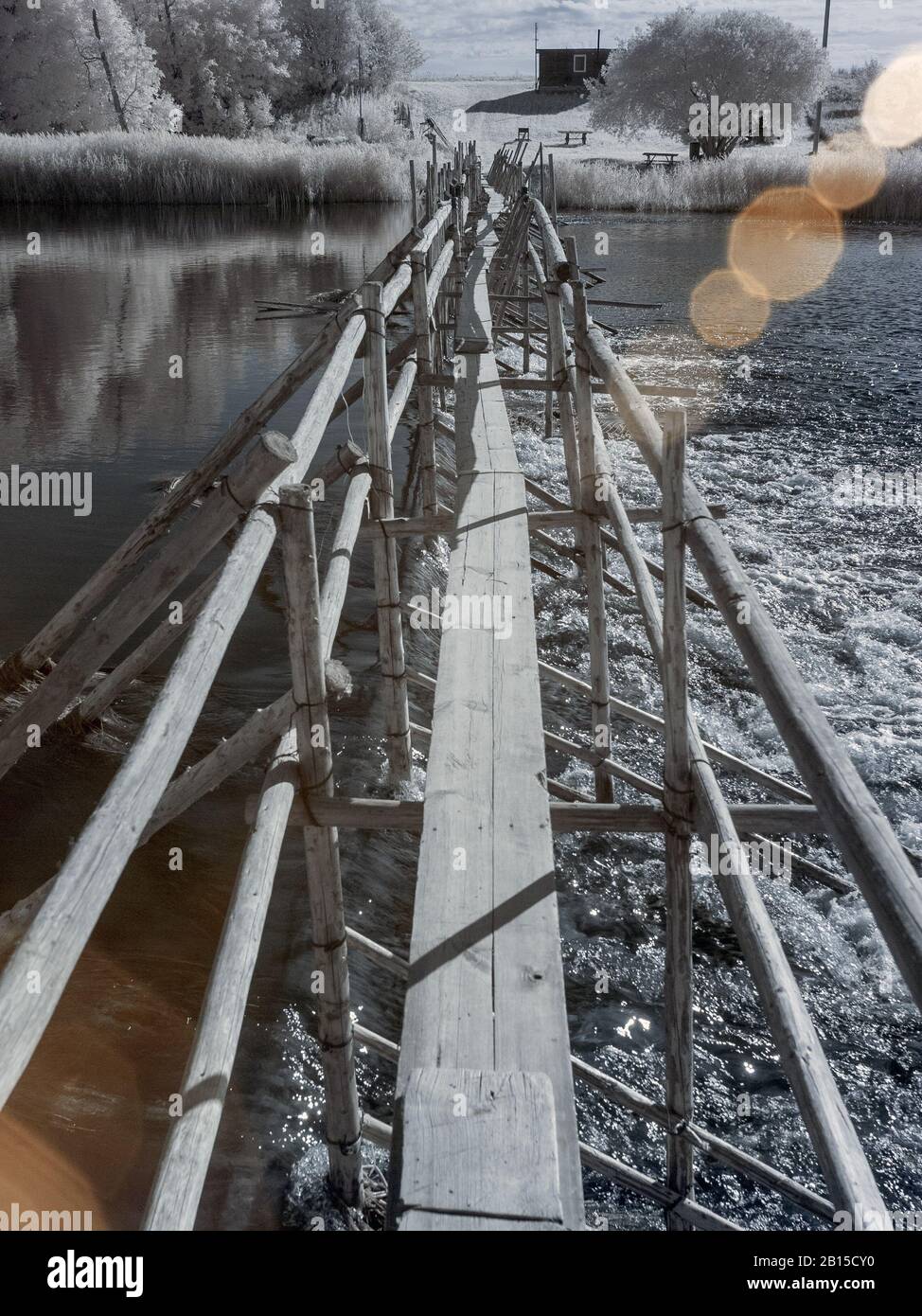 unusual landscape with wooden bridge over river, infrared photo taken ...